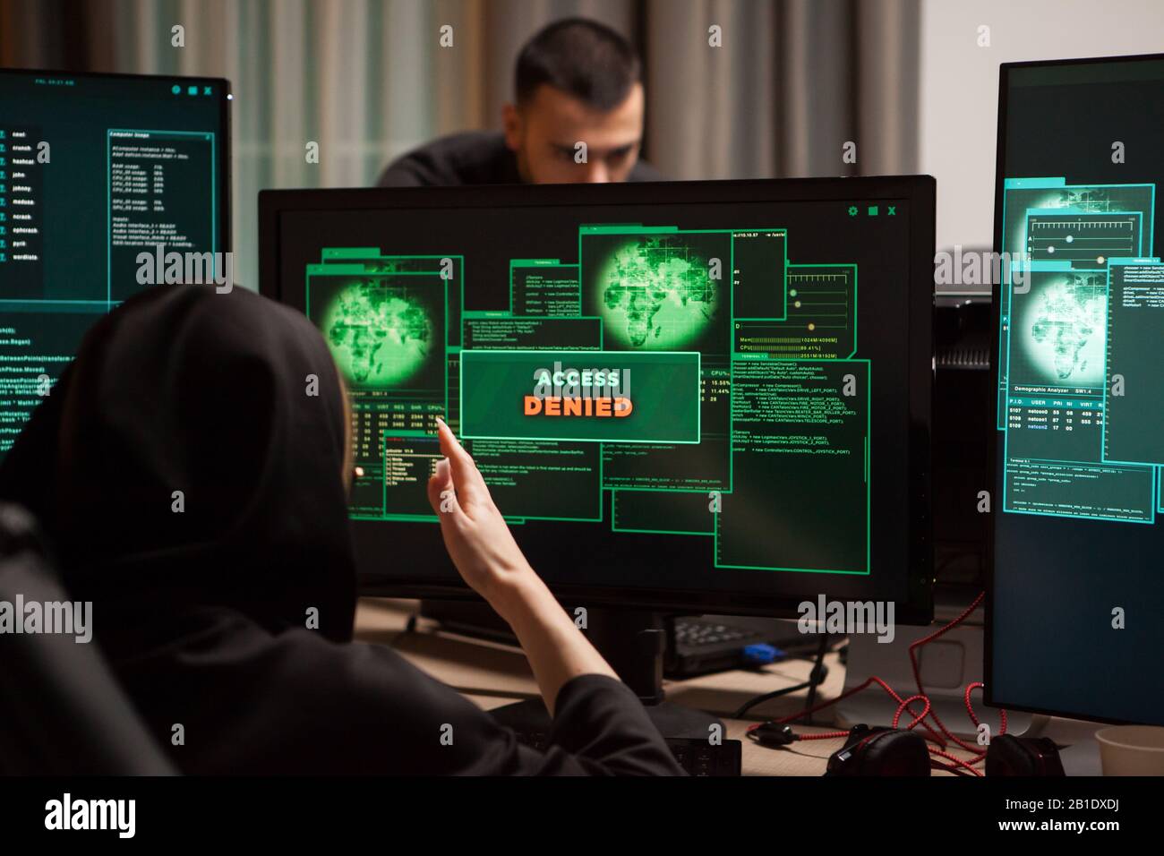 Back view of angry female hacker after access denied showing on ...