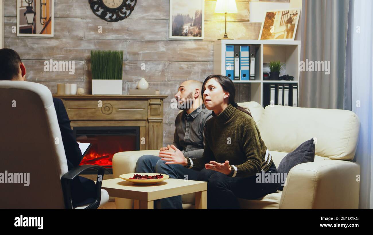 Angry wife on sofa at couple therapy yelling. Relationship conflict ...