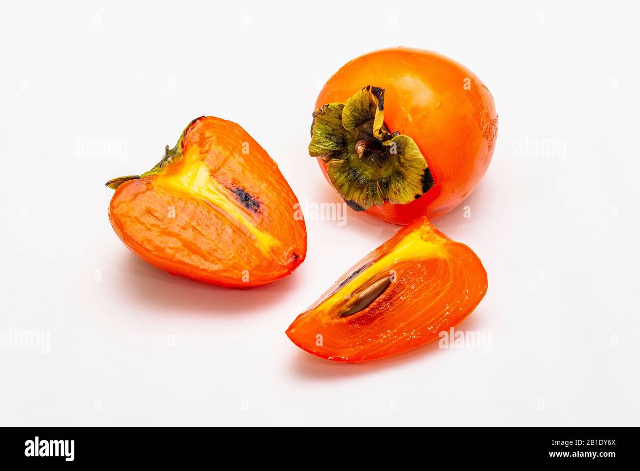 Ripe single persimmon. Fresh whole fruit, half sliced, seeds. Isolated ...