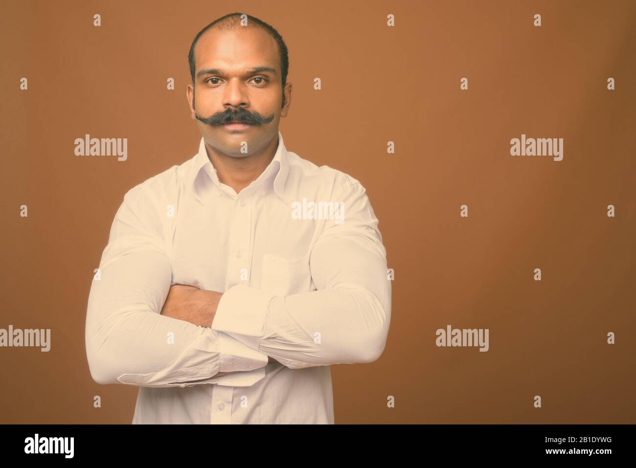 Indian businessman with mustache against brown background Stock Photo ...