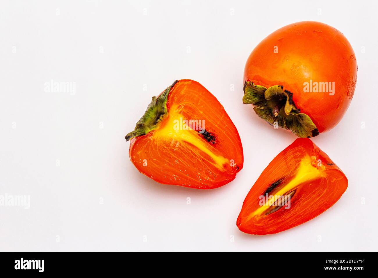 Ripe single persimmon. Fresh whole fruit, half sliced, seeds. Isolated ...