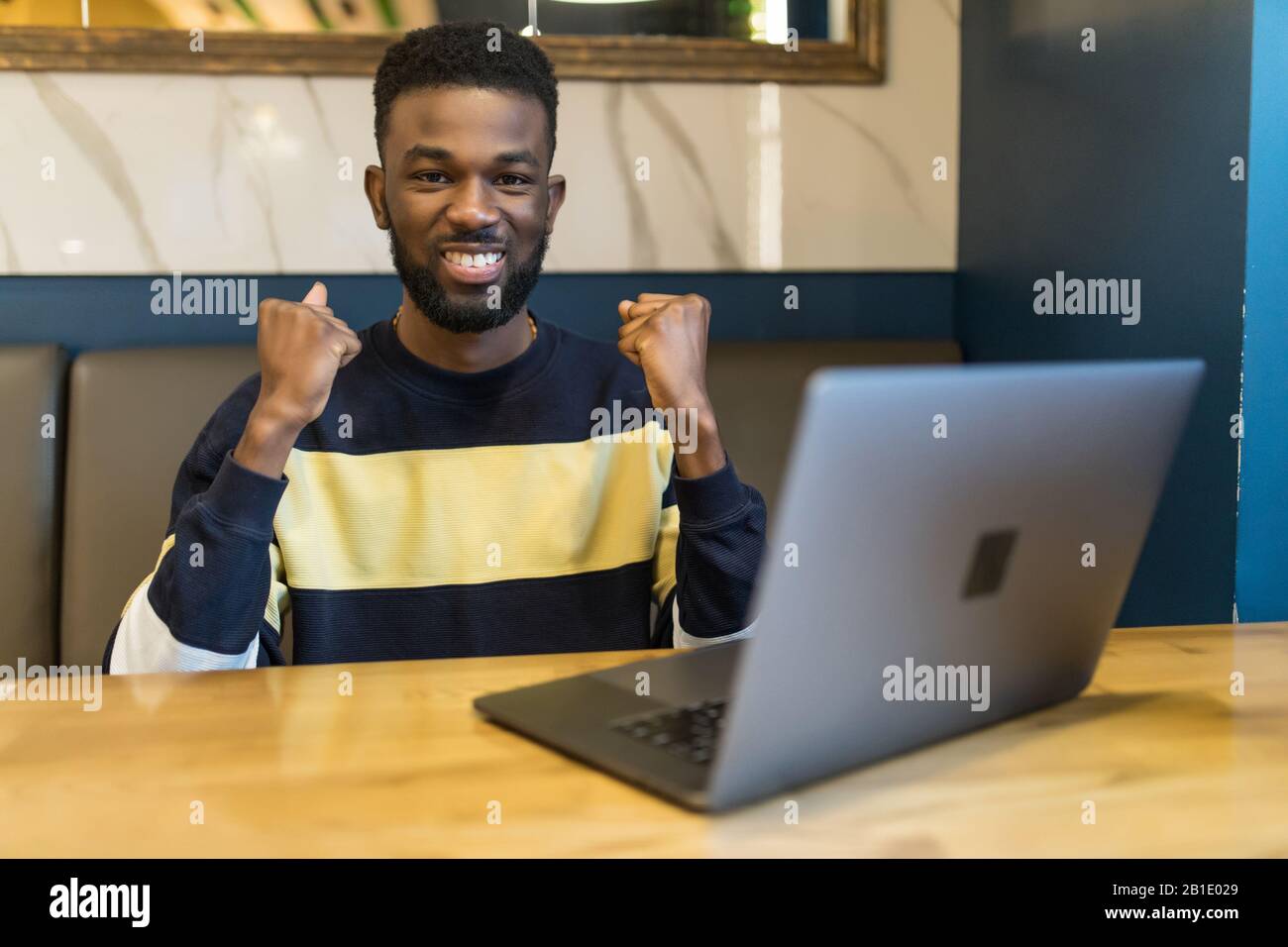 African man celebrating on laptop hi-res stock photography and images ...