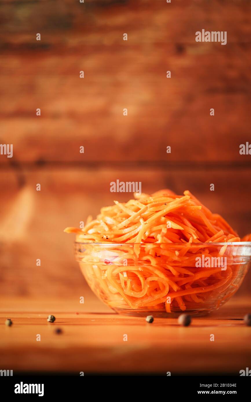 Spicy korean carrot salad on wooden background. Copy space. Koryo-saram ...
