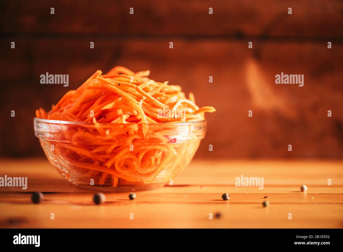 Spicy korean carrot salad on wooden background. Copy space. Koryo-saram ...