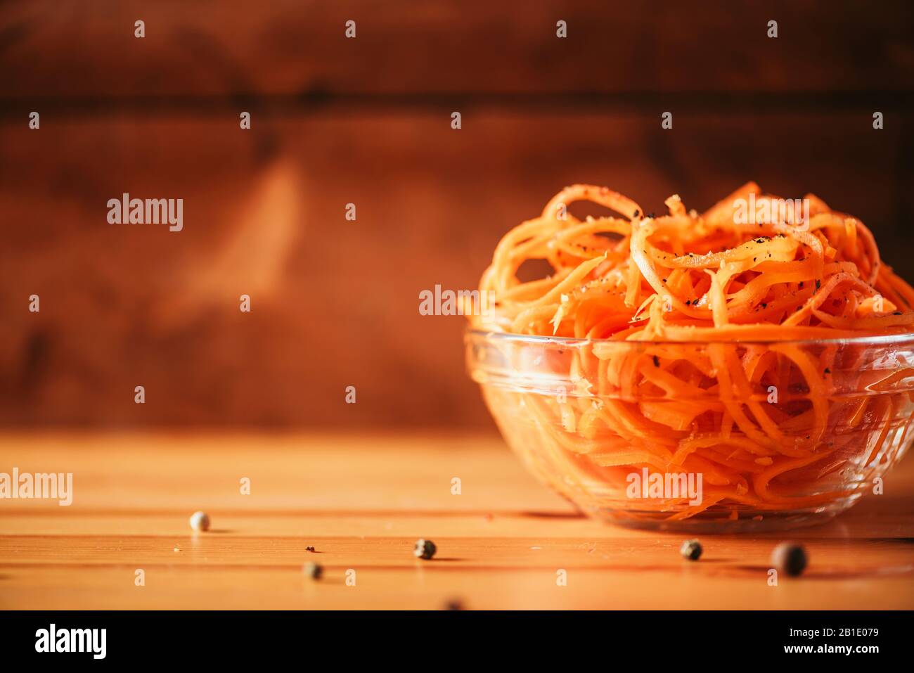 Spicy korean carrot salad on wooden background. Copy space. Koryo-saram ...