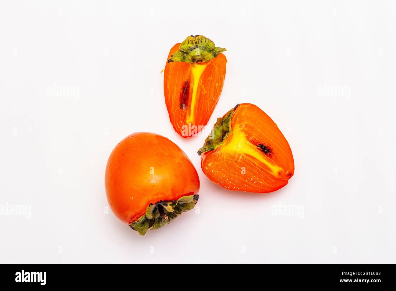 Ripe single persimmon. Fresh whole fruit, half sliced, seeds. Isolated ...
