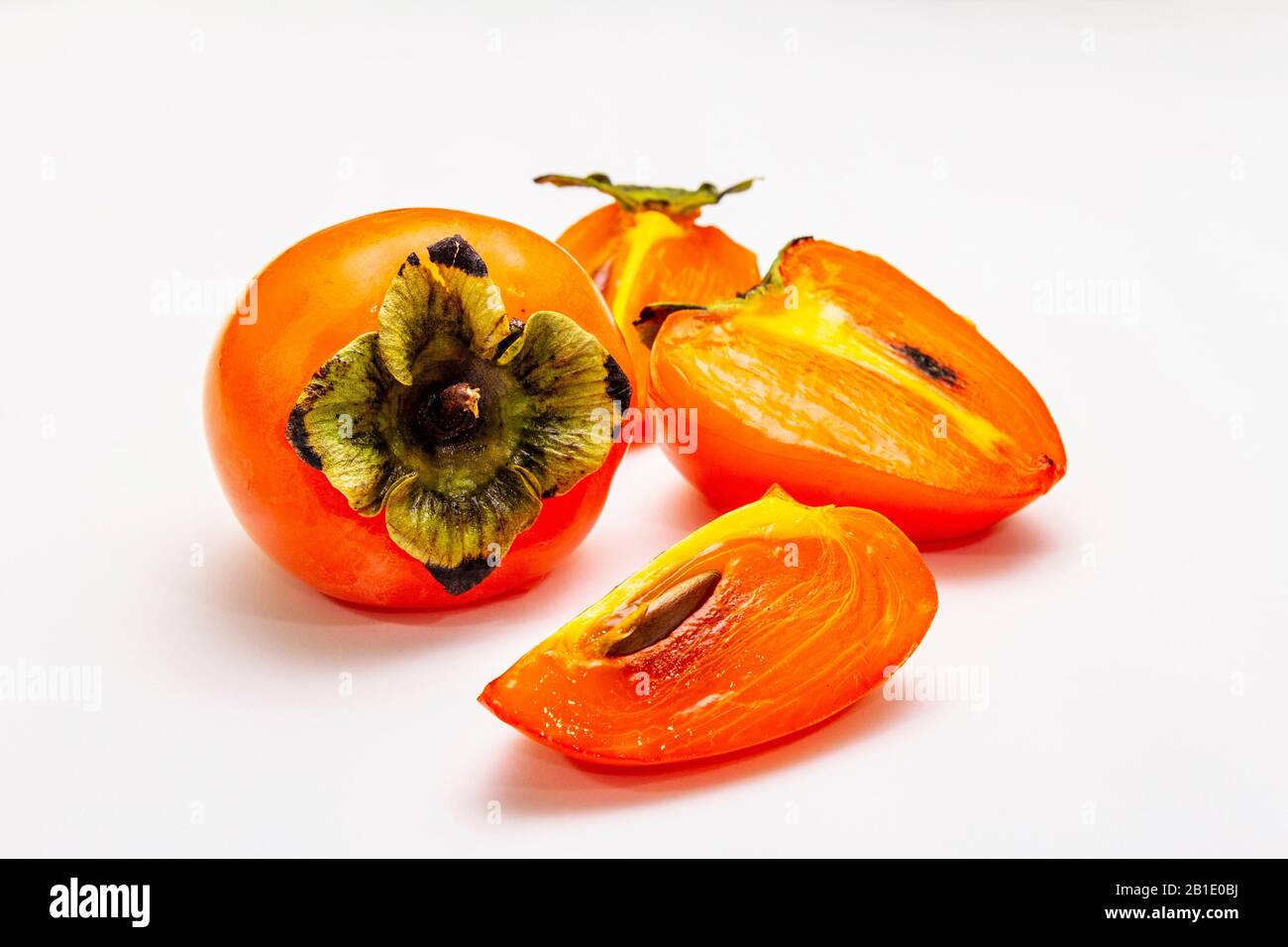 Ripe single persimmon. Fresh whole fruit, half sliced, seeds. Isolated ...