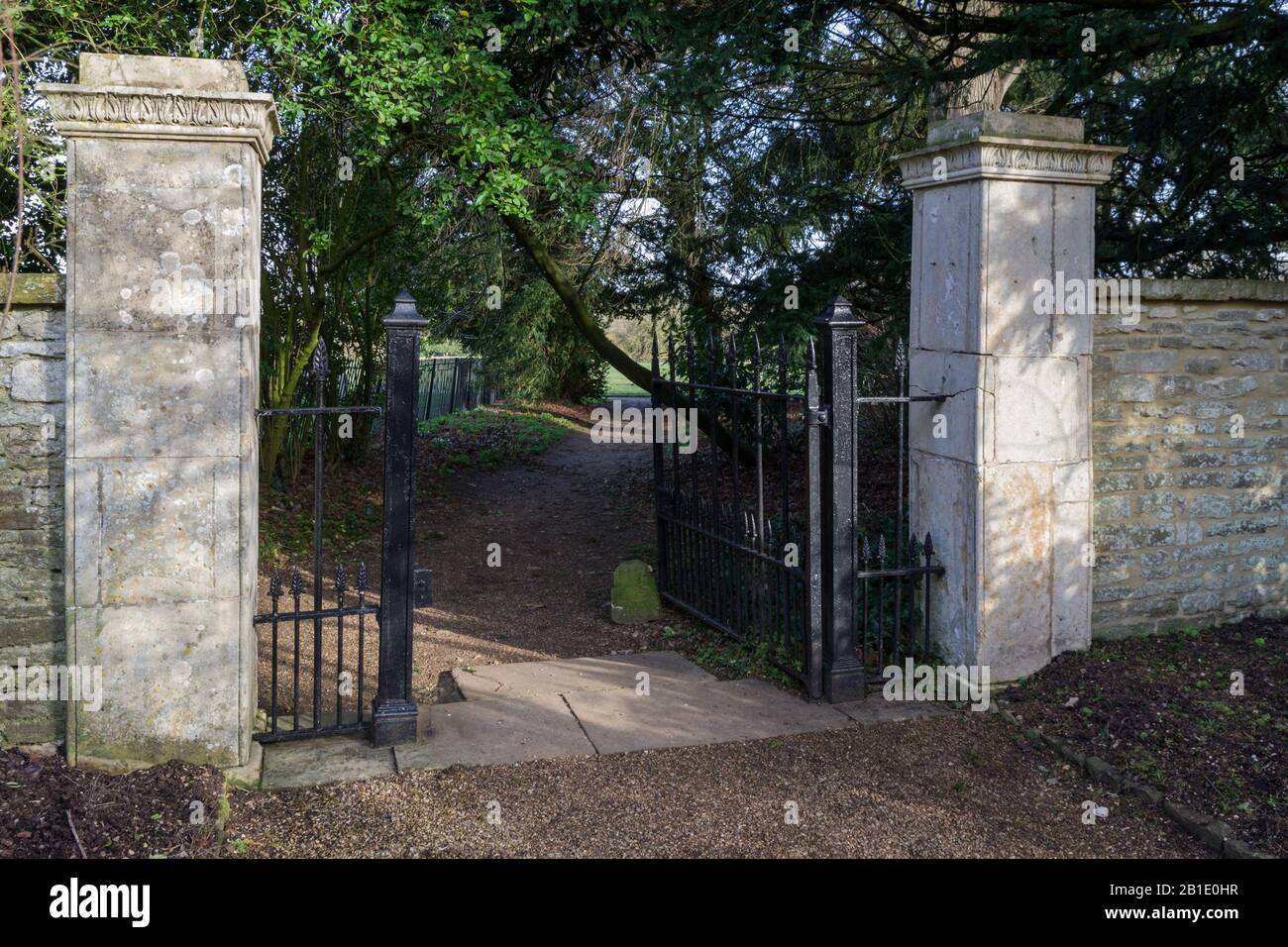 Open black cast iron gate leading to the parkland area of Castle Ashby ...