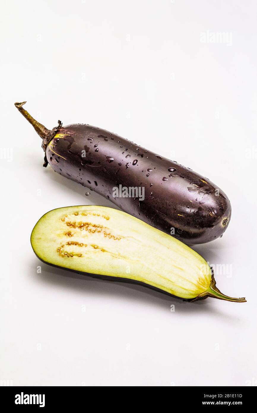 Ripe single eggplant. Fresh whole and half vegetable. Isolated on white ...