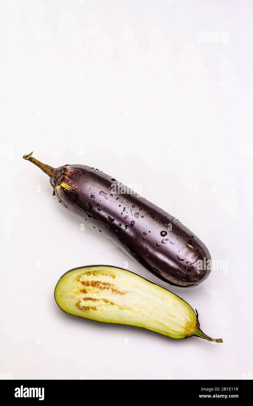 Ripe single eggplant. Fresh whole and half vegetable. Isolated on white ...