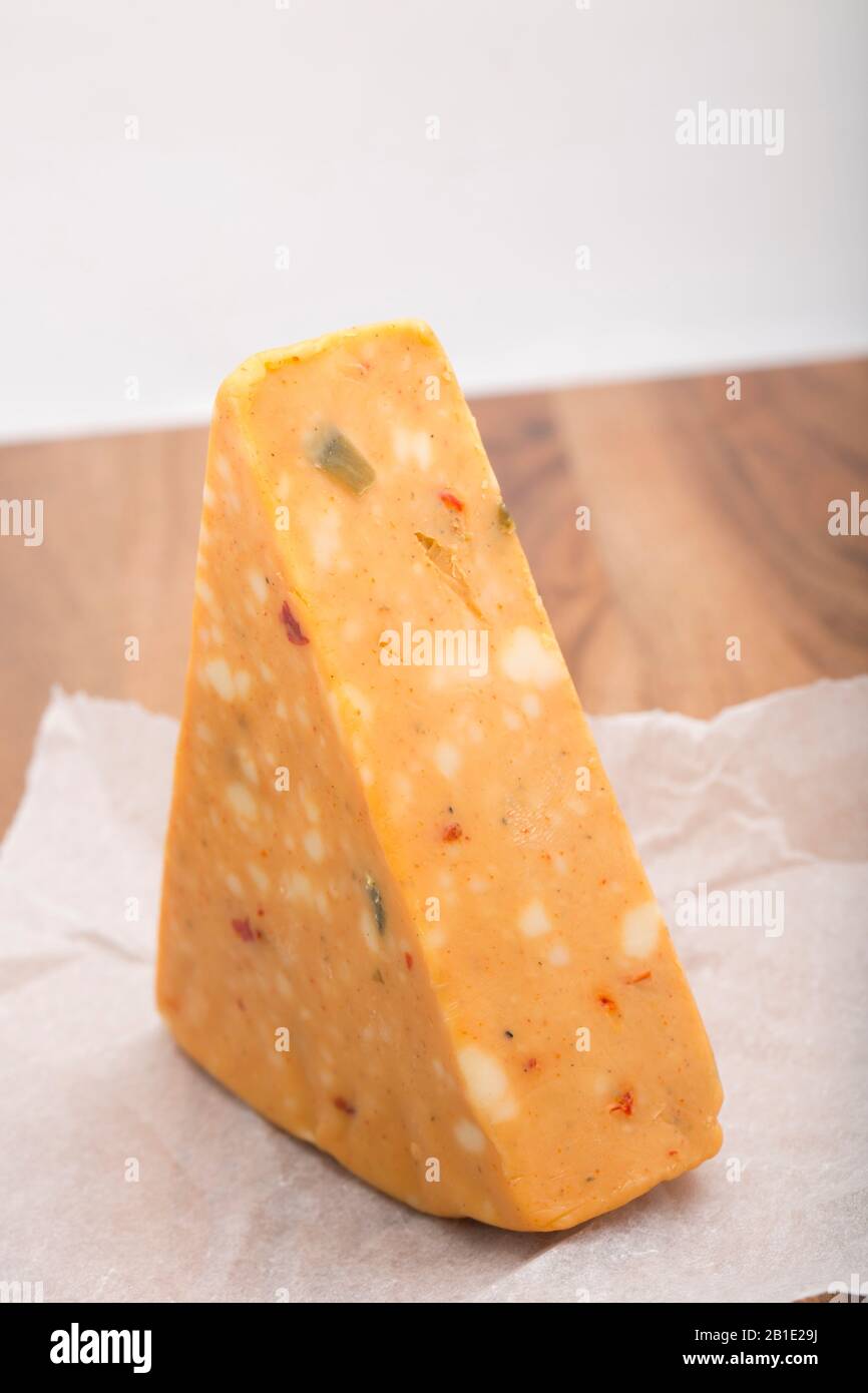 A wedge of Cheddar Mexicana cheese bought from a Waitose supermarket ...