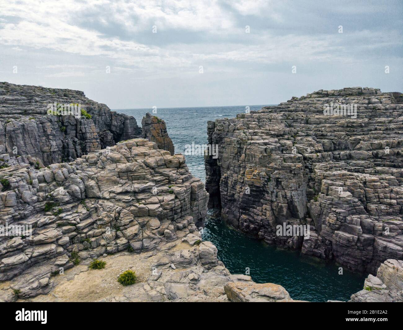 Amazing view over cliffs on San Pietro island , huge gray rocky strata ...