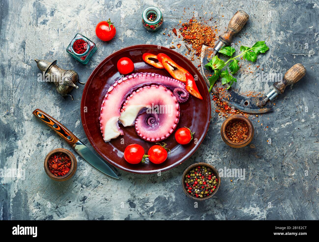 Fresh raw octopus and spice on plate.Uncooked octopus tentacles ...