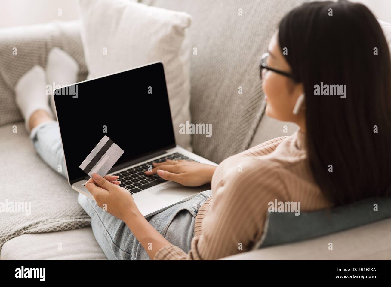 Girl making online purchase on laptop computer Stock Photo - Alamy