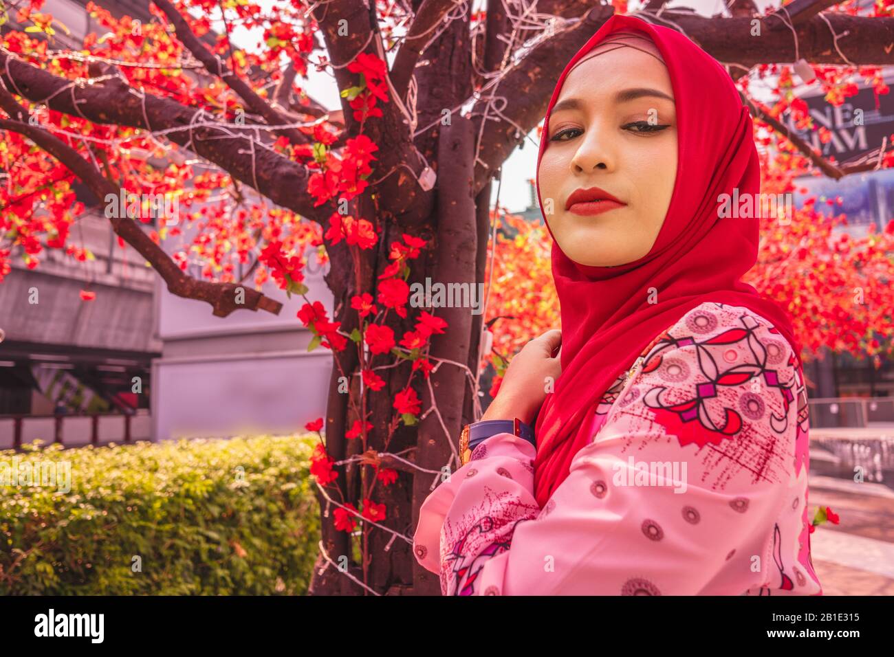 beautiful islamic lady enjoy with red Sakura in the park of center ...