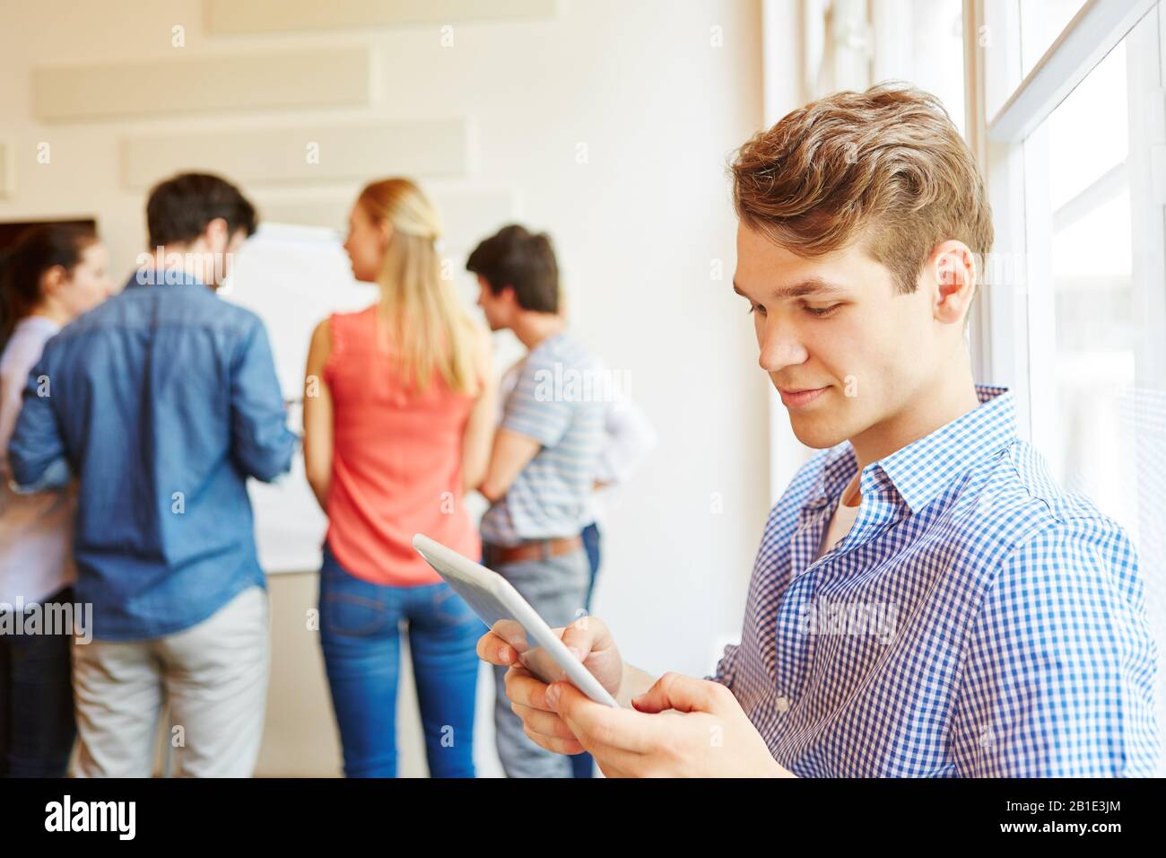 Student looks at a tablet computer in the university Stock Photo - Alamy