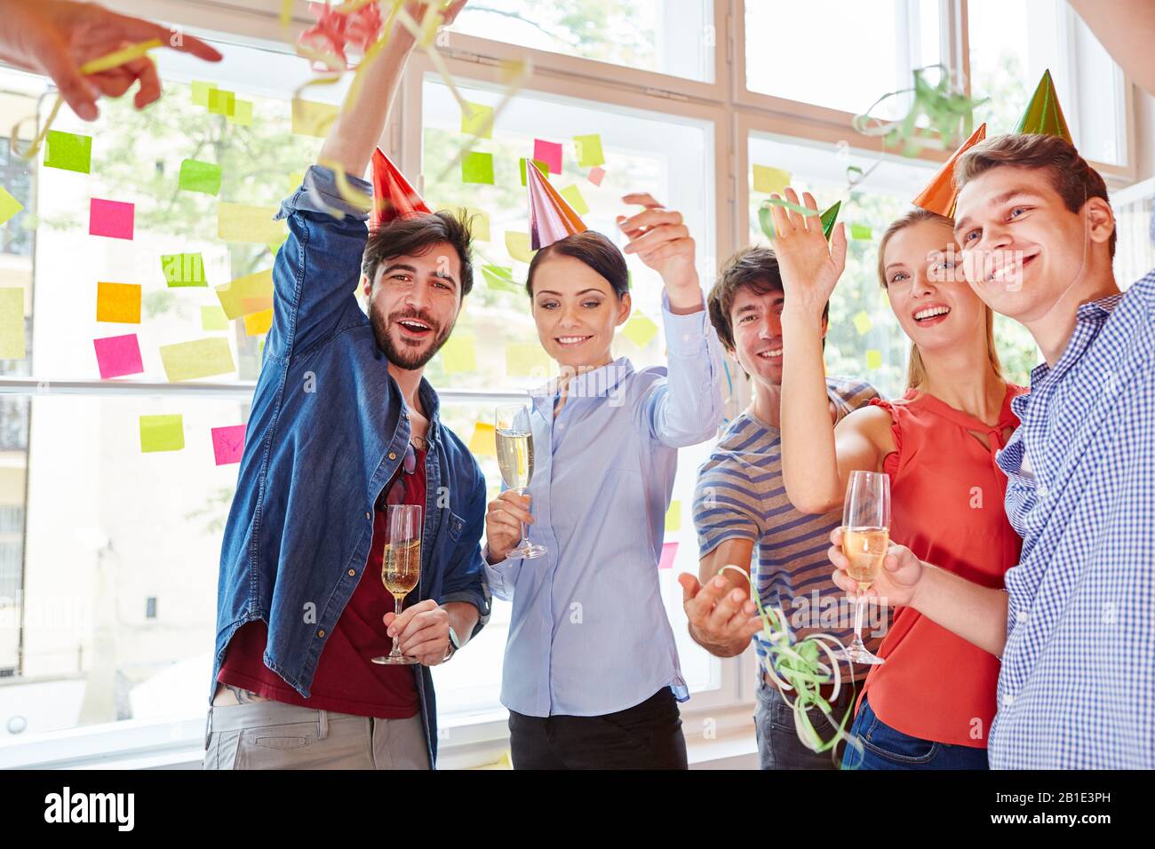 Start-up team celebrates party at a company party with sparkling wine ...