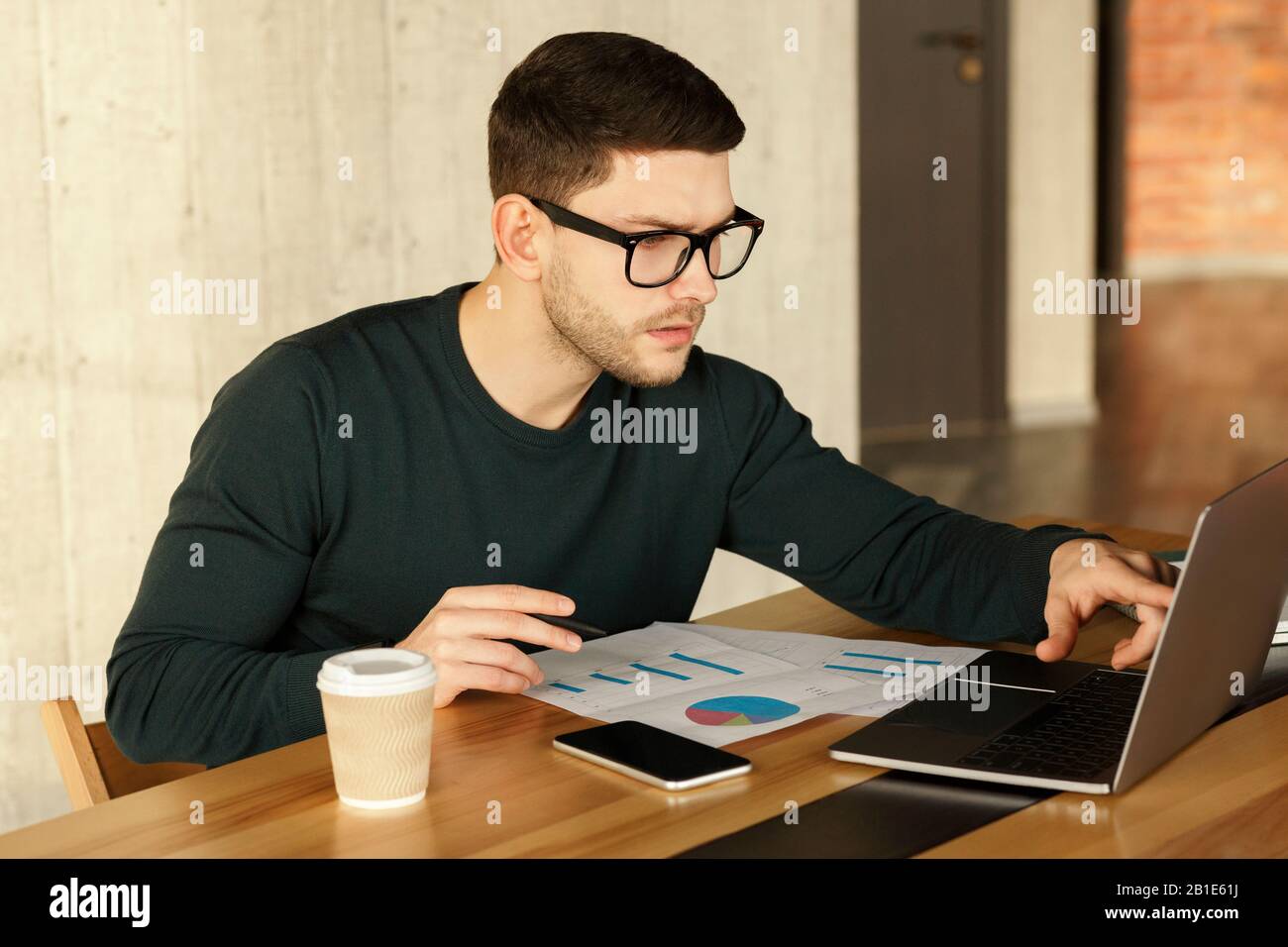 Busy Young Man Working With Charts Sitting At Workplace Indoor Stock ...