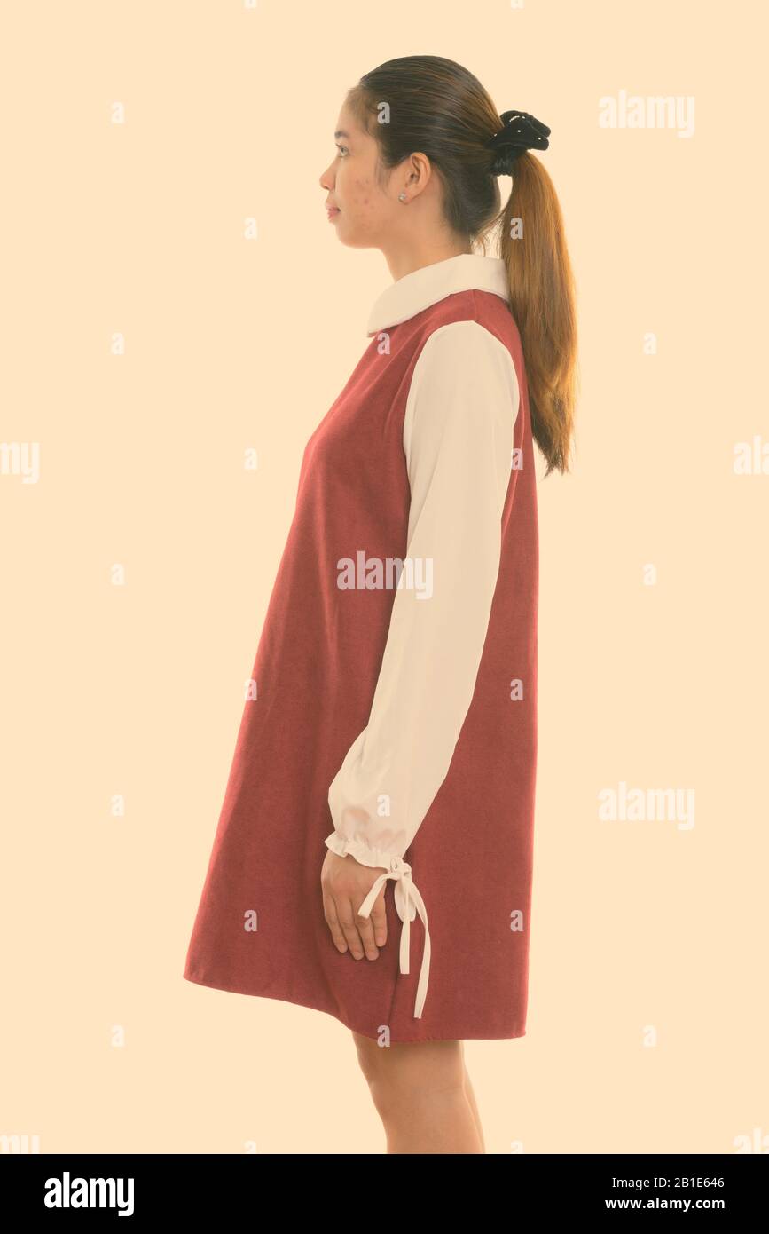 Profile view of young Asian woman standing Stock Photo - Alamy
