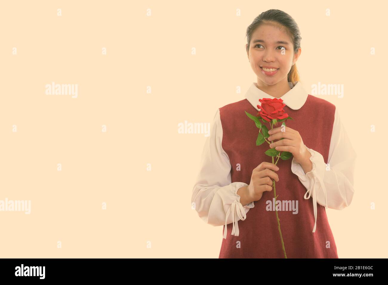Smiling lady red rose looking hi-res stock photography and images - Alamy