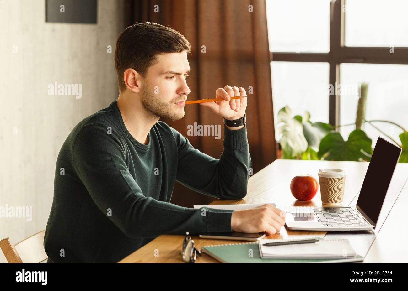 Pensive Guy Thinking On Business Idea Sitting At Desk Indoor Stock ...
