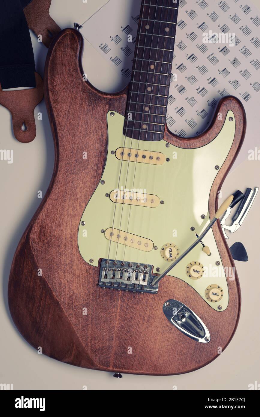 Natural wood Stratocaster guitar on rustic background Stock Photo - Alamy