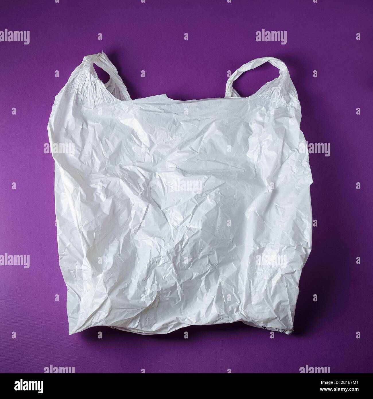 Square photo of the White Wrinkled Plastic Bag On Purple Background ...