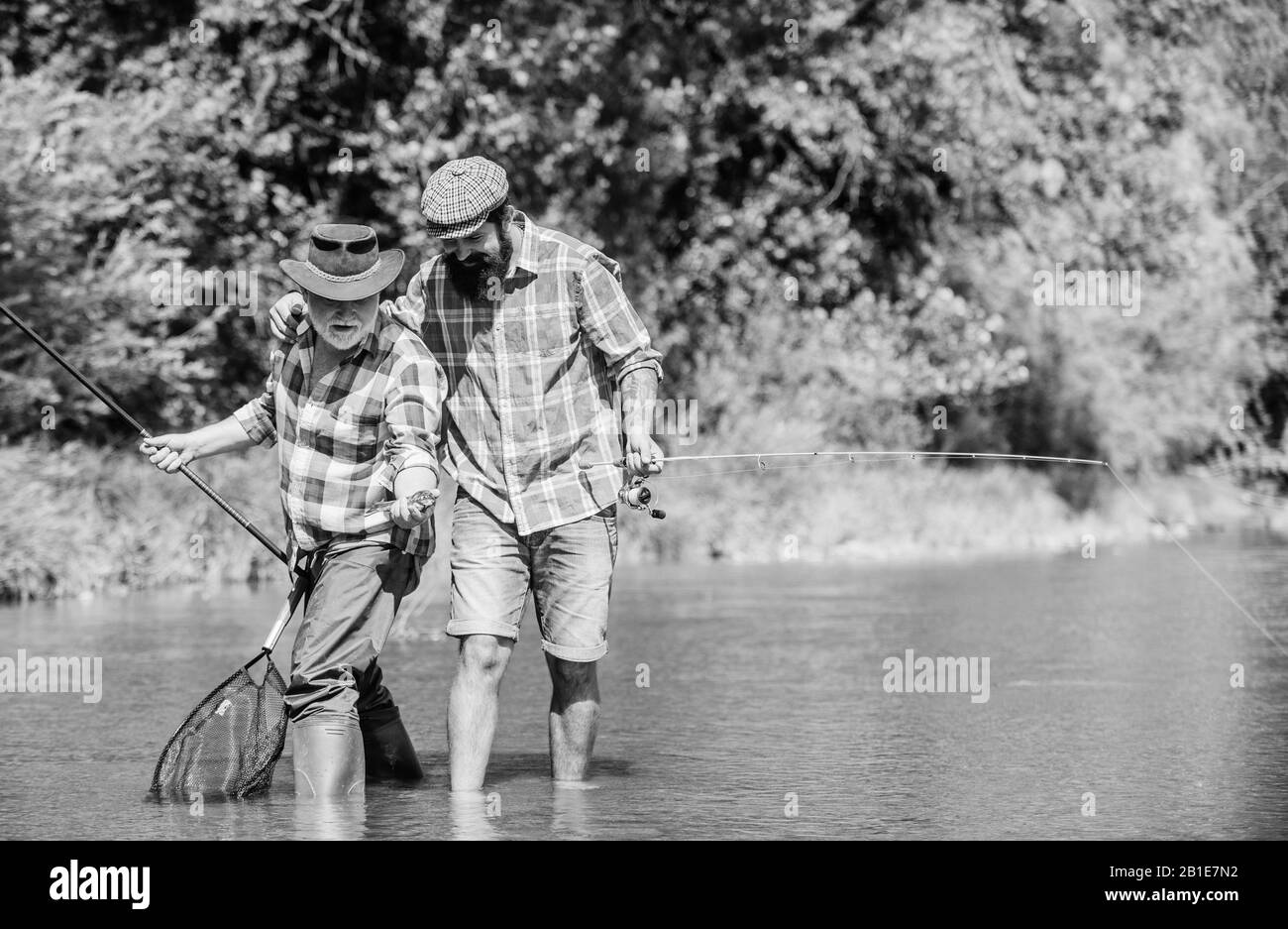 Father and son fishing. Nice catch. Rod and tackle. Fisherman fishing ...
