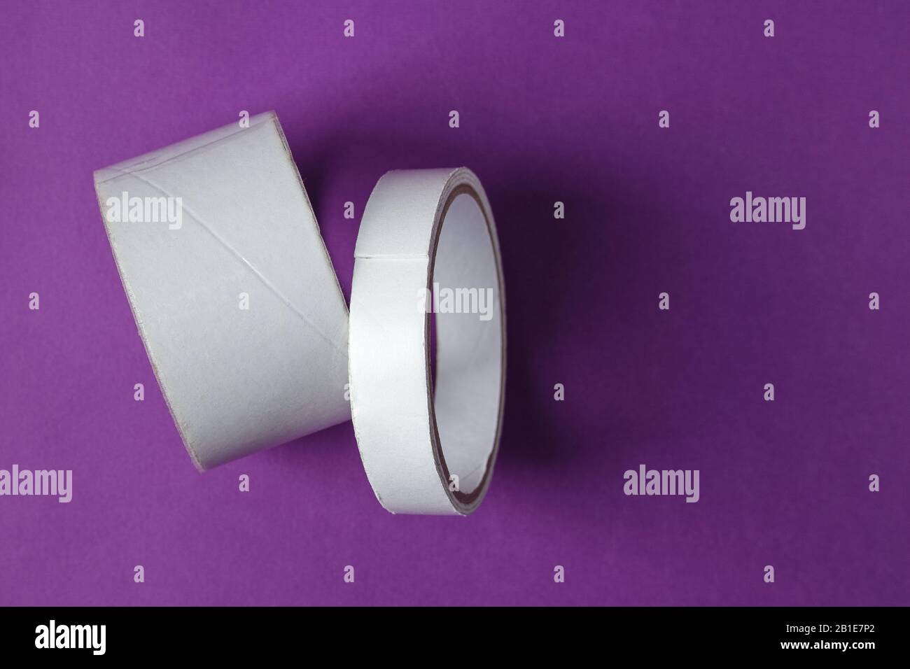 Two rolls of sticky adhesive scotch tape on purple background Stock ...
