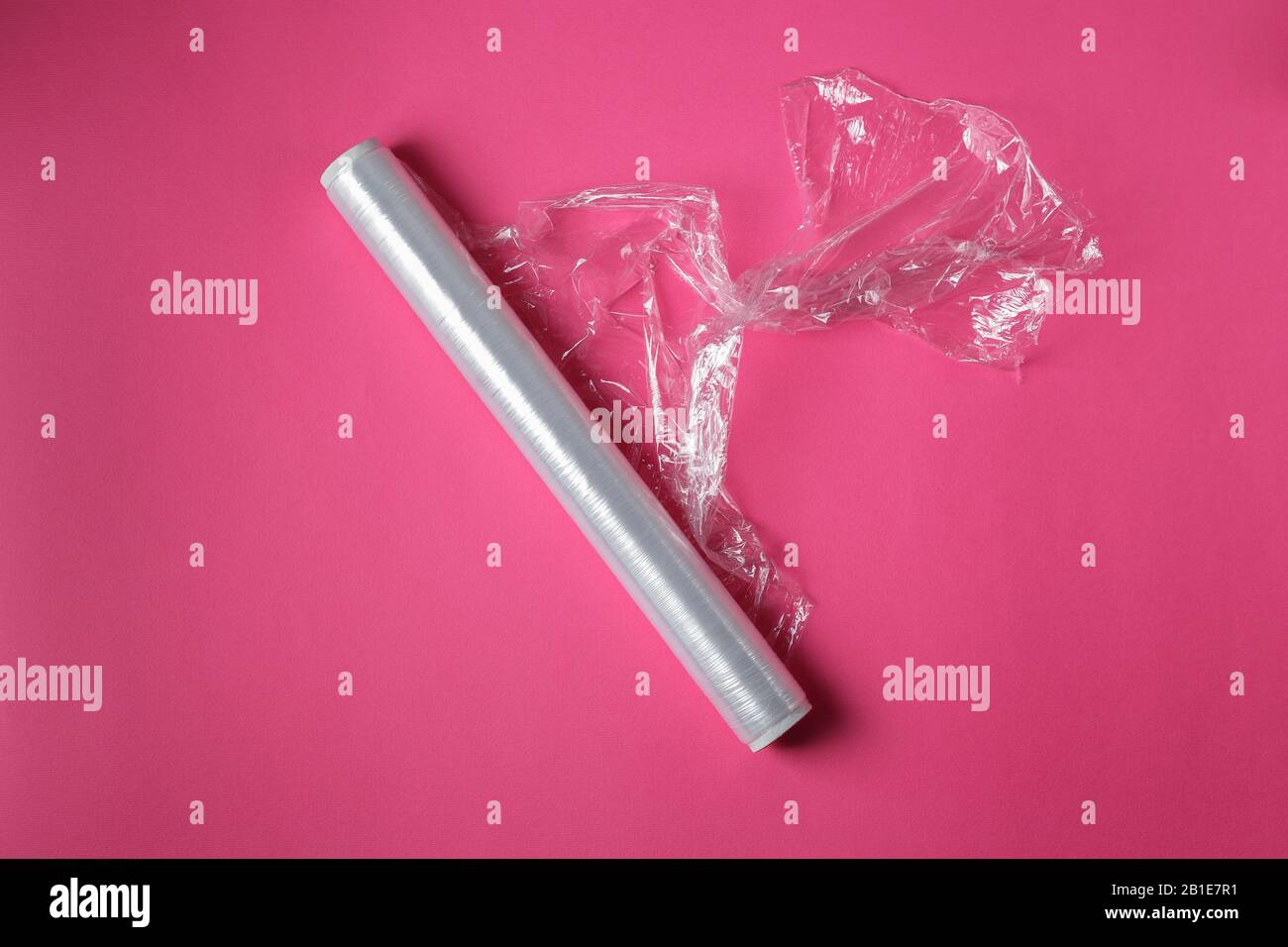 Wrapping plastic stretch film on the pink background Stock Photo - Alamy
