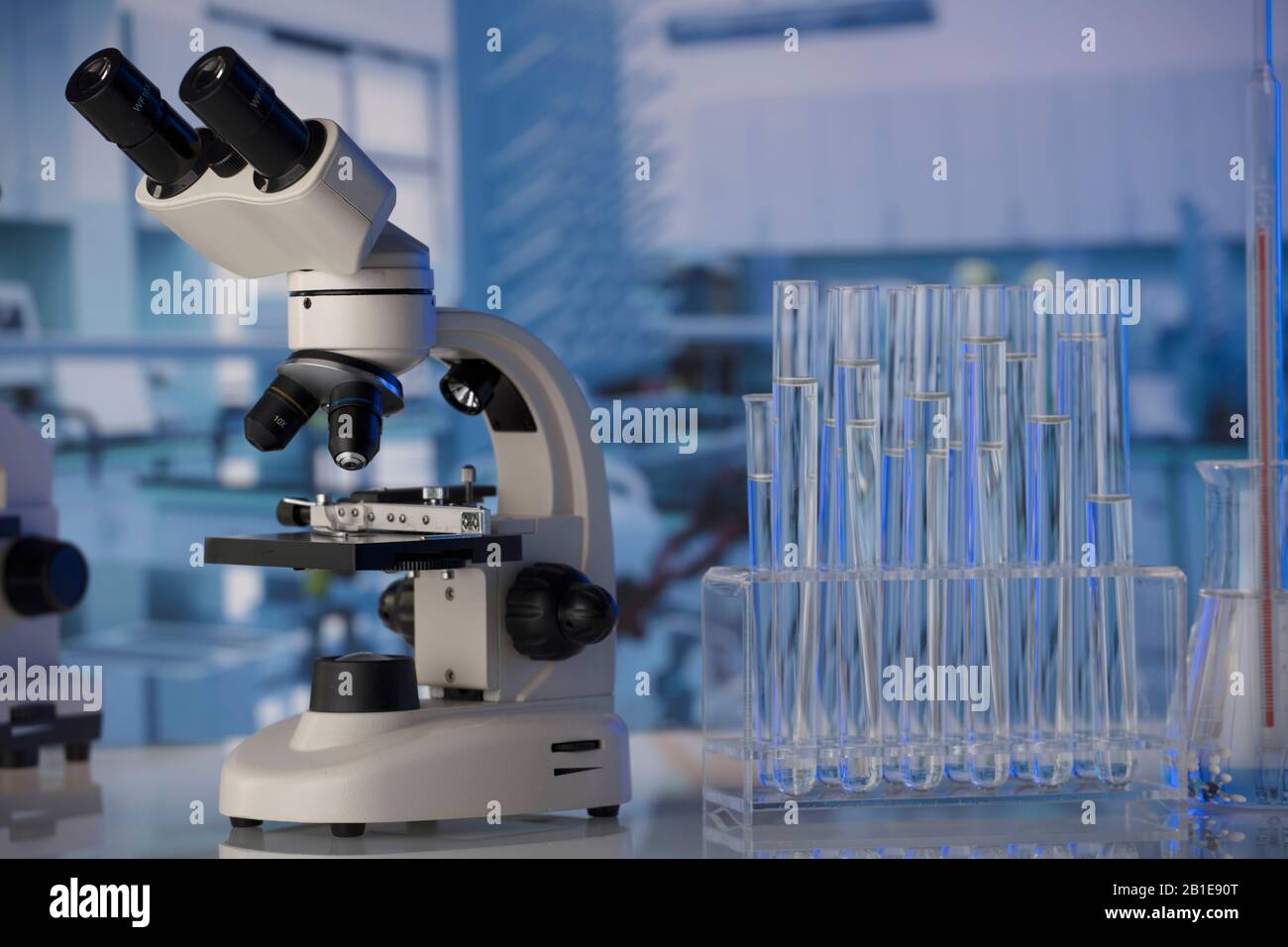 Science laboratory. Beakers, test-tubes and microscope on glass table ...