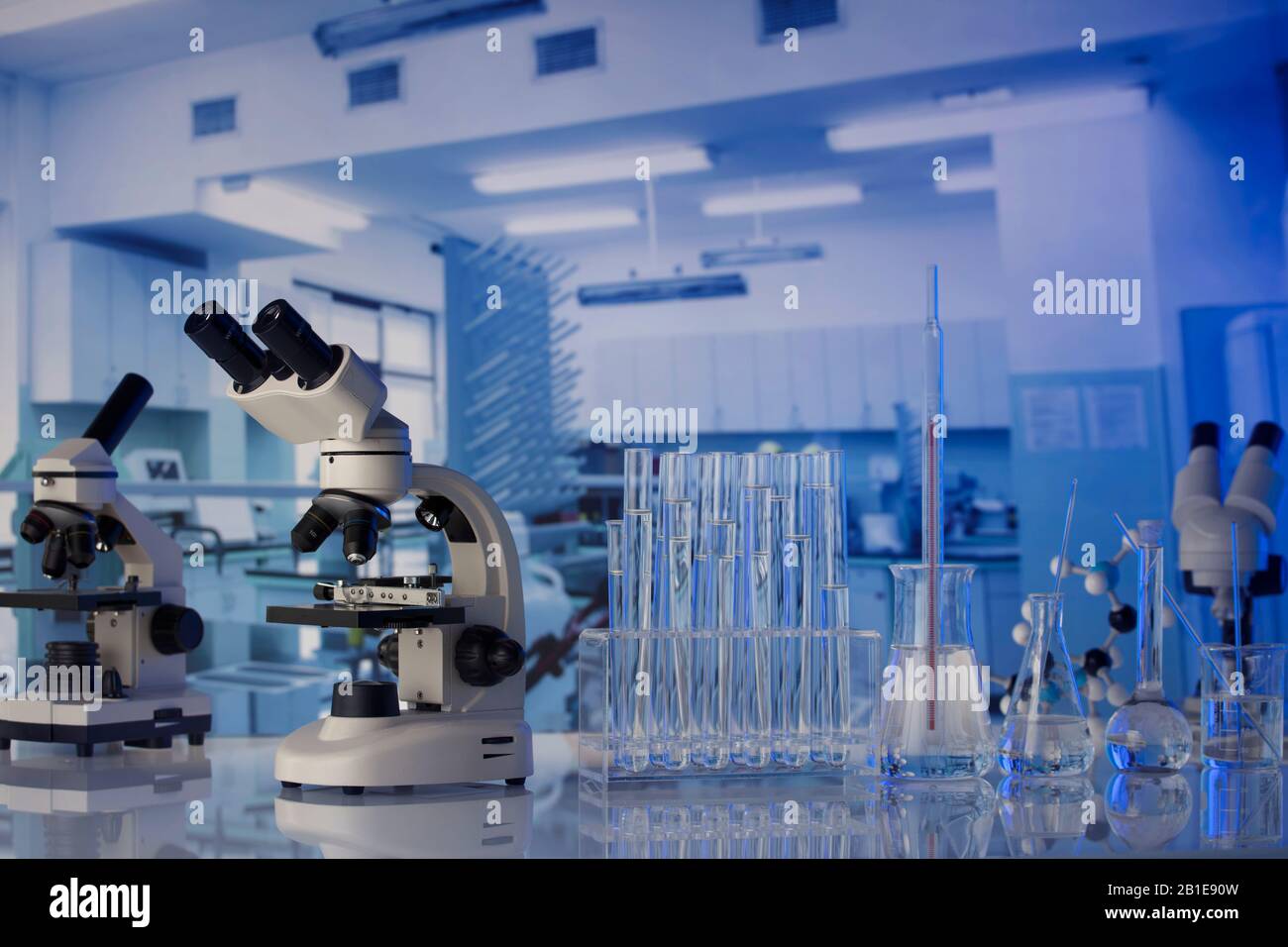 Science laboratory. Beakers, test-tubes and microscope on glass table ...