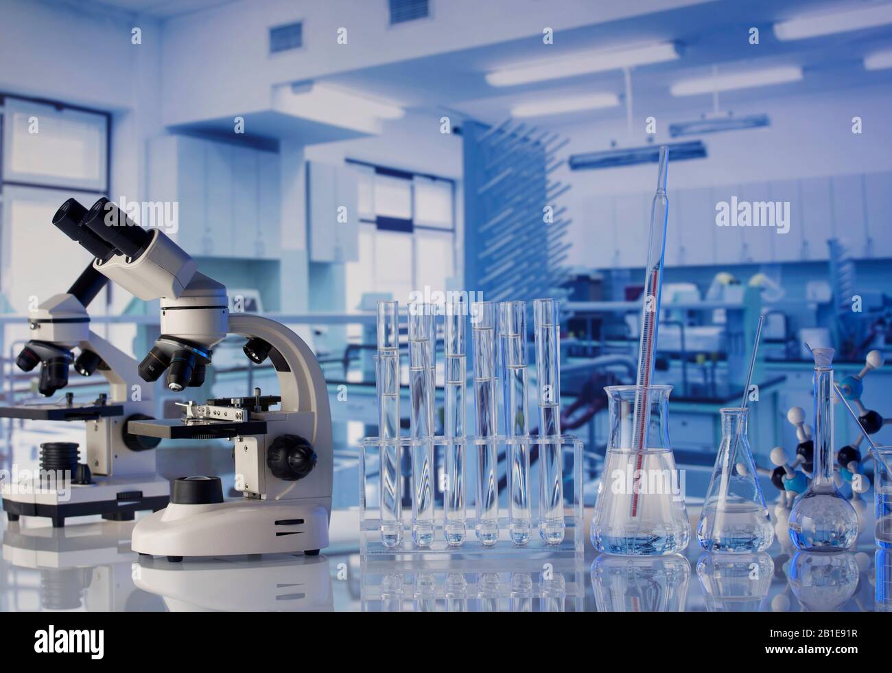 Science laboratory. Beakers, test-tubes and microscope on glass table ...