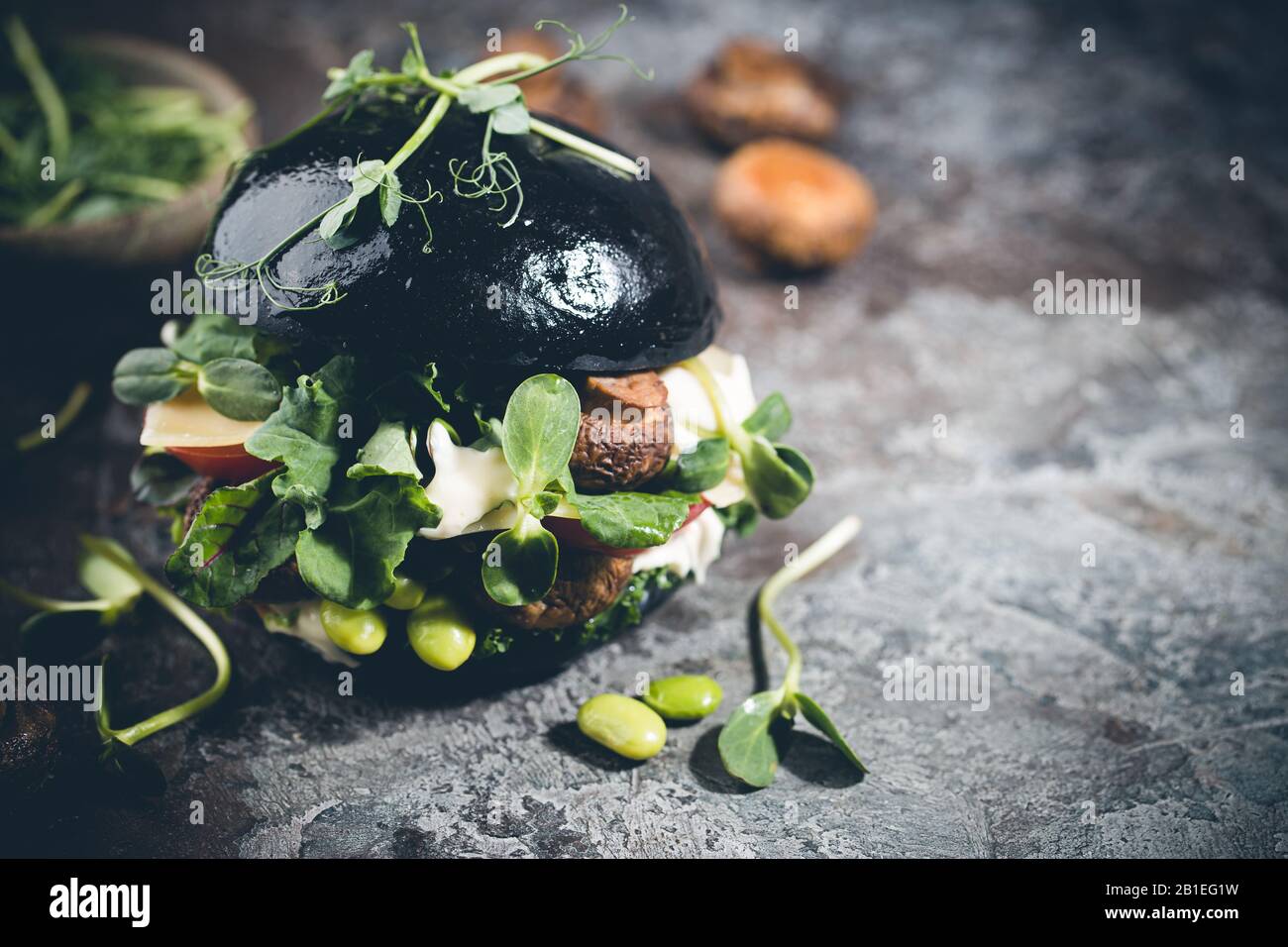 Veggie mushroom, green salad and vegetable black burgers. on gray stone ...