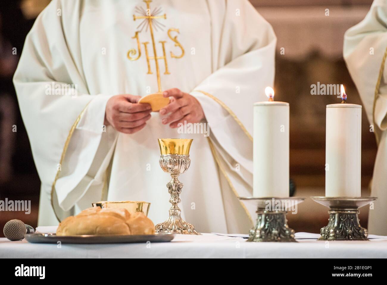 Minister showing the holy bread during the rite of the Holy Communion ...