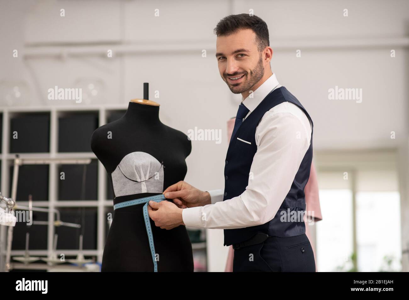Male tailor measuring dummy size with measuring tape Stock Photo - Alamy