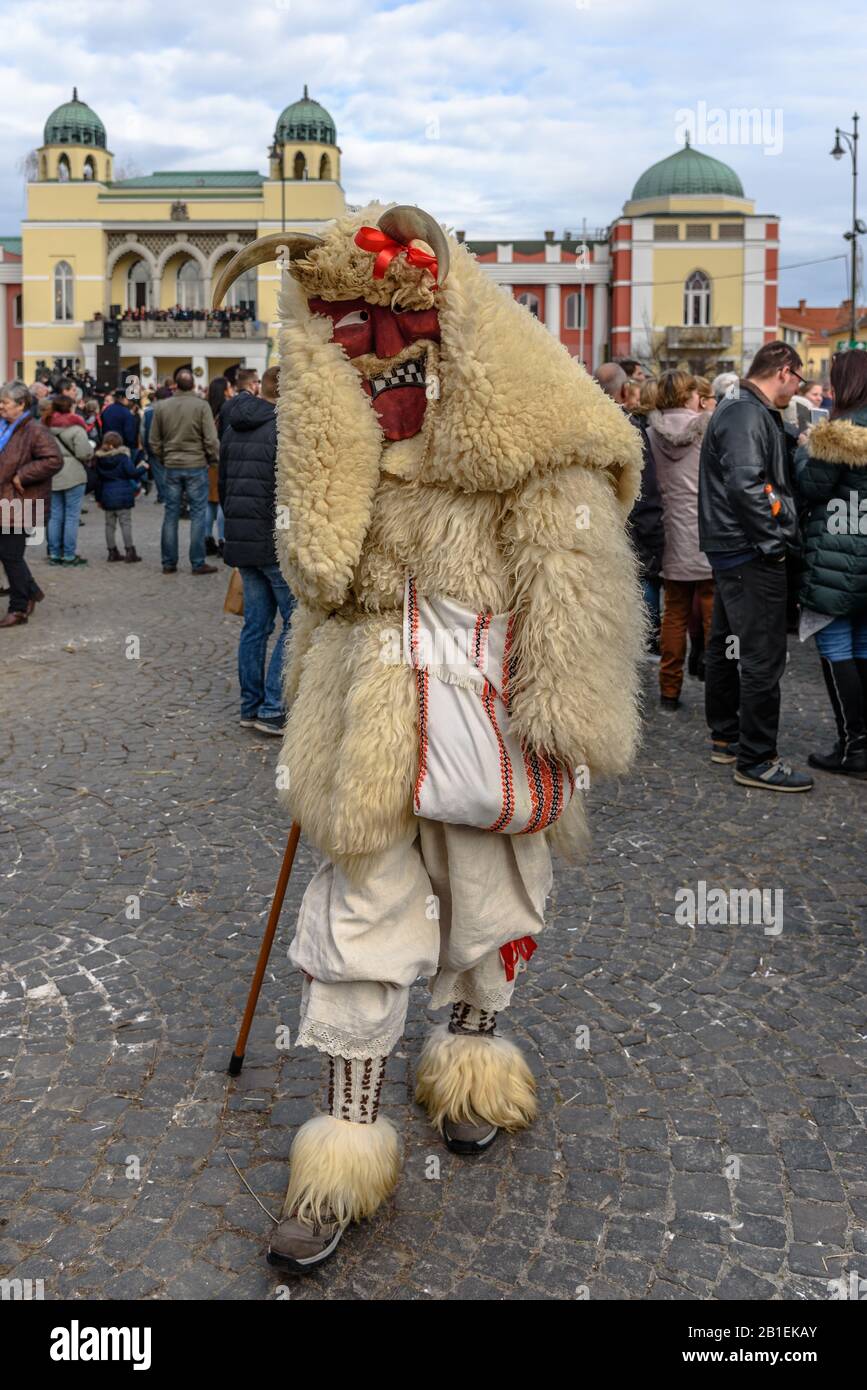 A masked buso walking in the procession at the 2020 Busojaras carnival ...