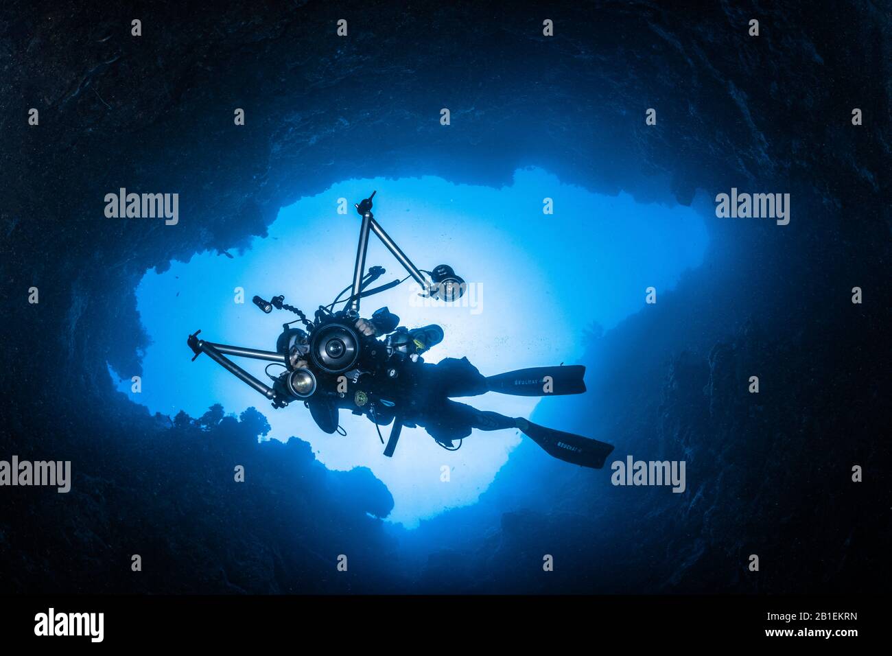 Inside the reef. Underwater photographer in an underwater cave, Misool ...