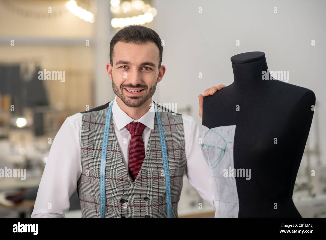 Male fashing designer with his hand on dummy Stock Photo - Alamy