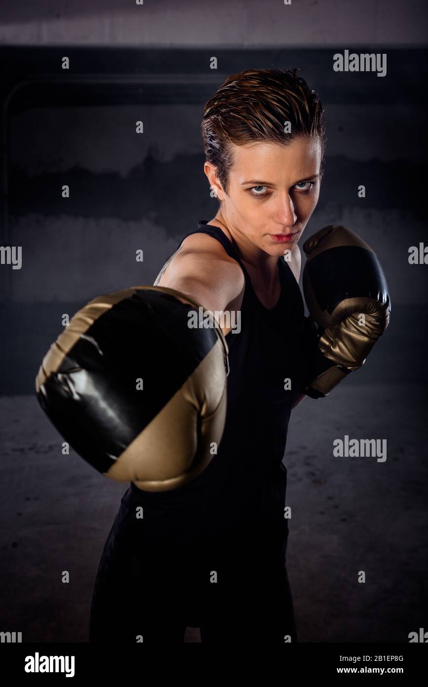 Closeup image with smokey background of a female boxer punching with ...