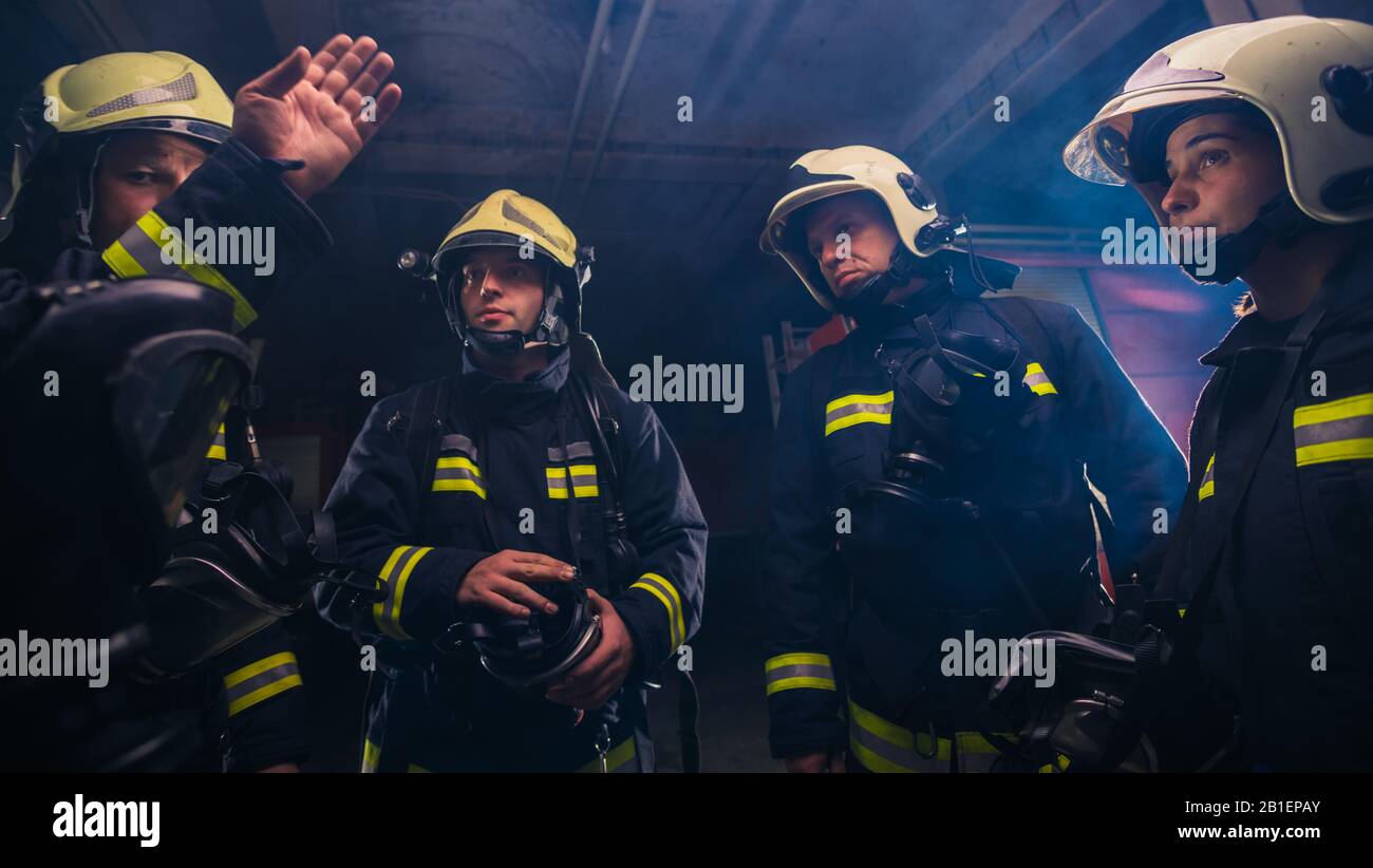 Group of firemen in the fire department organizing action plan for safe ...