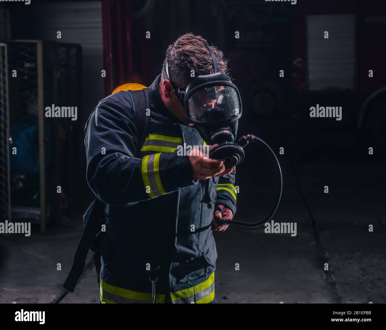 Firefighter with protective uniform wearing oxygen mask Stock Photo - Alamy