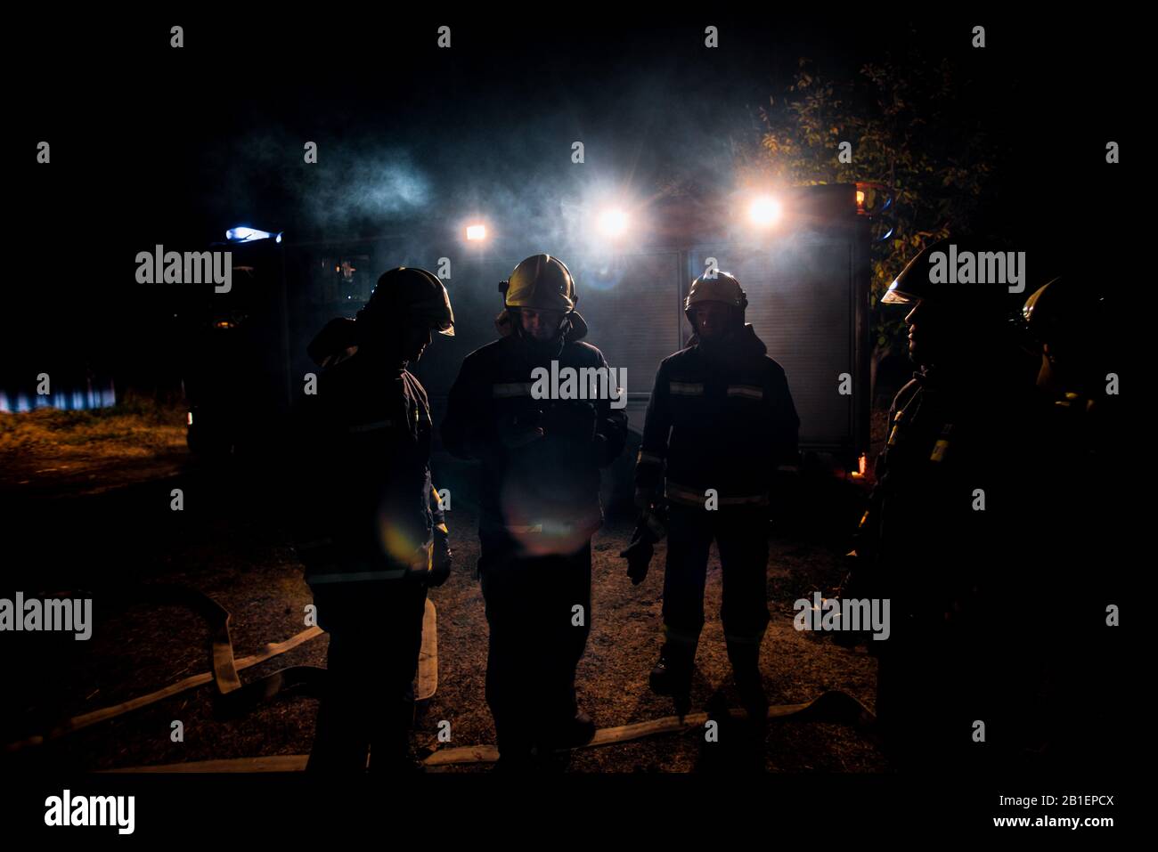 Fire brigade during operation in the field at night time Stock Photo ...