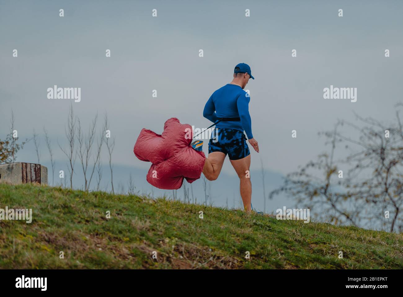 Senior man is runs on the track. Functional training of the runner with ...