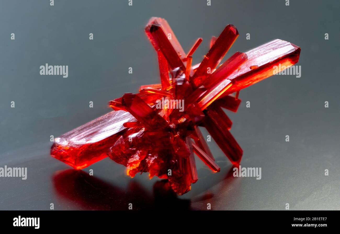 Red crystalline minerals on a black background Stock Photo - Alamy