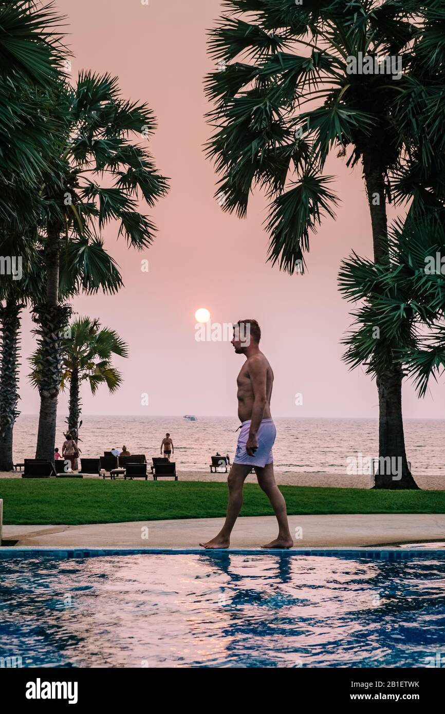 men relax on the beach in Pattaya Thailand Jomtien beach with beach ...