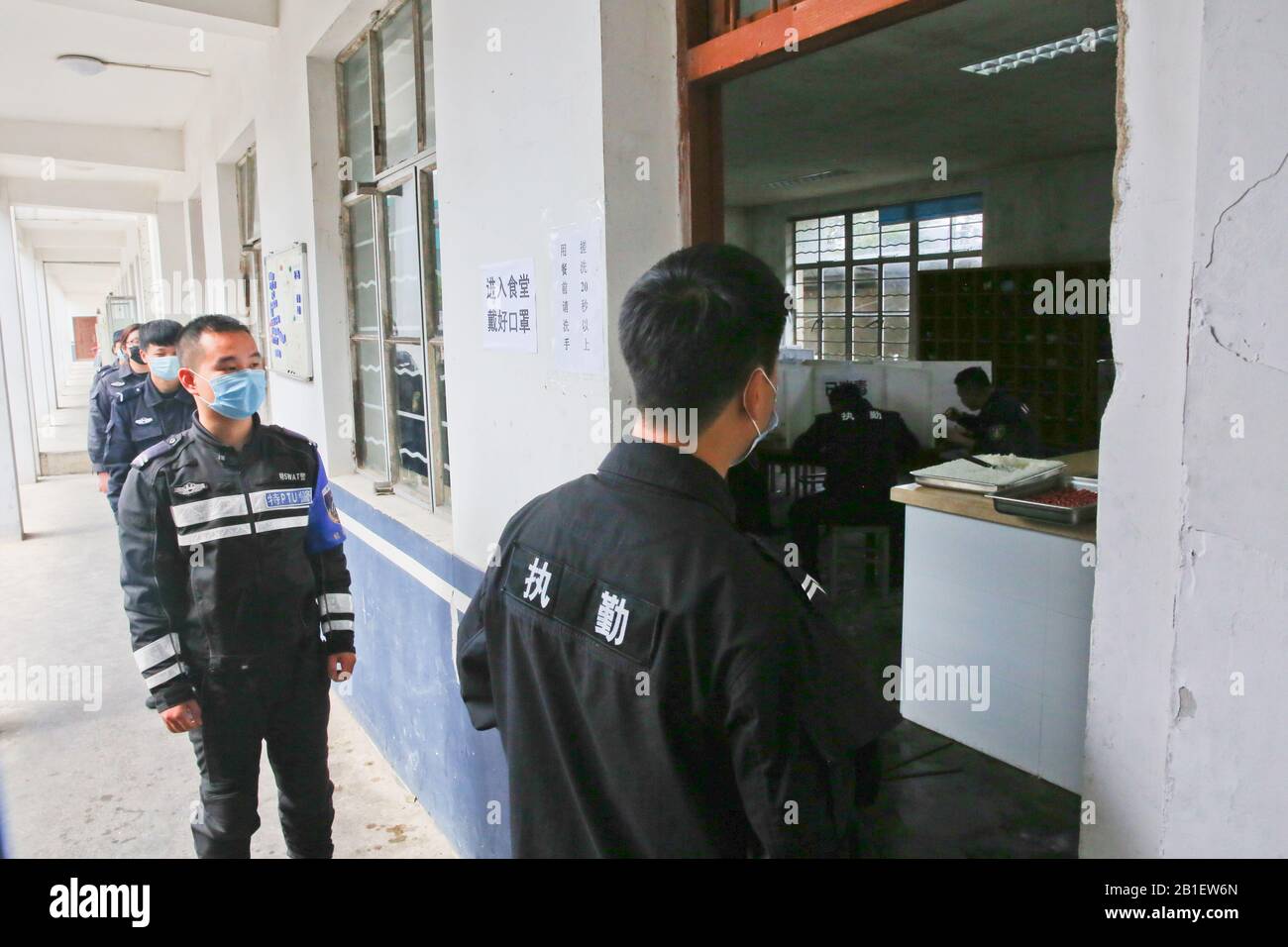 Chinese police officers and auxiliary policemen queue up to enter the ...