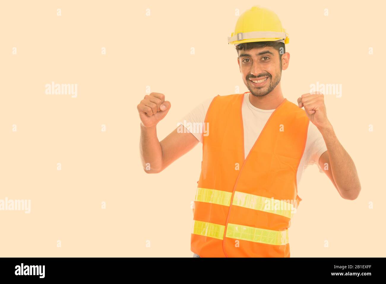 Young happy Persian man construction worker smiling while looking ...