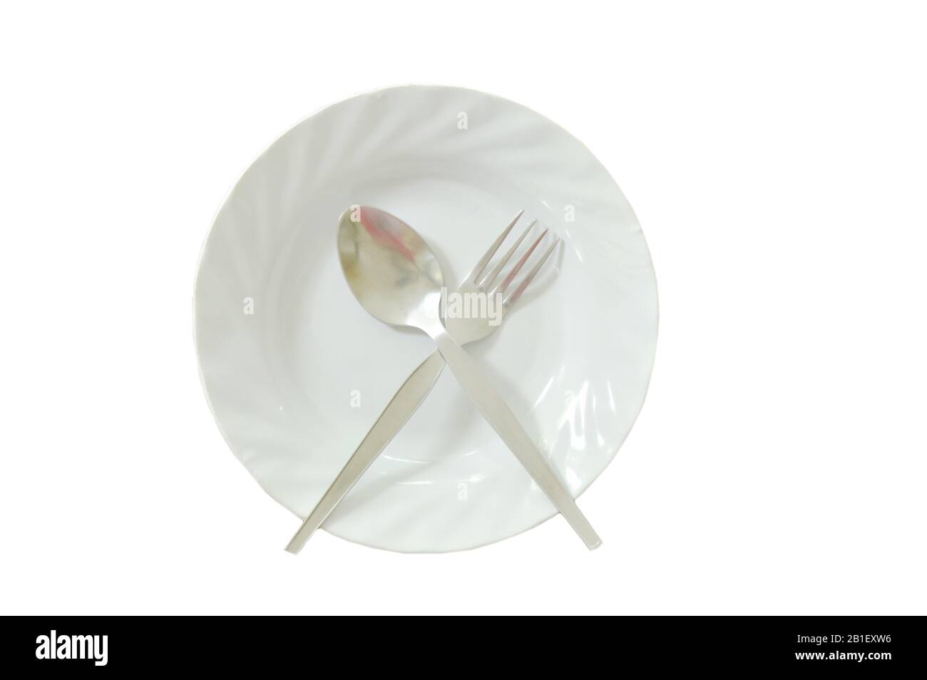 spoon and fork crossing on dish in white background Stock Photo - Alamy