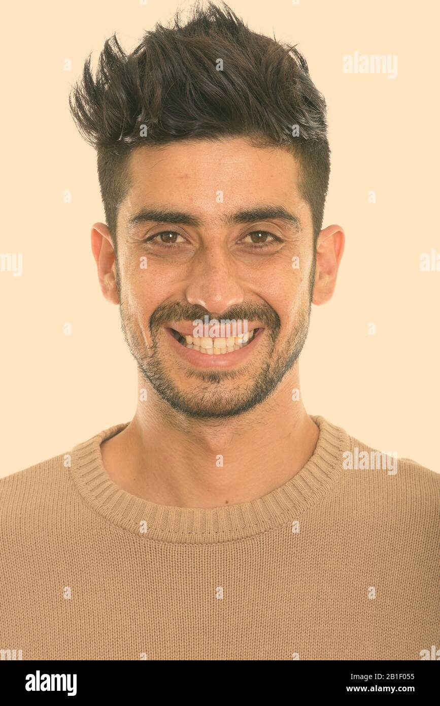 Face of young happy Persian man smiling Stock Photo - Alamy